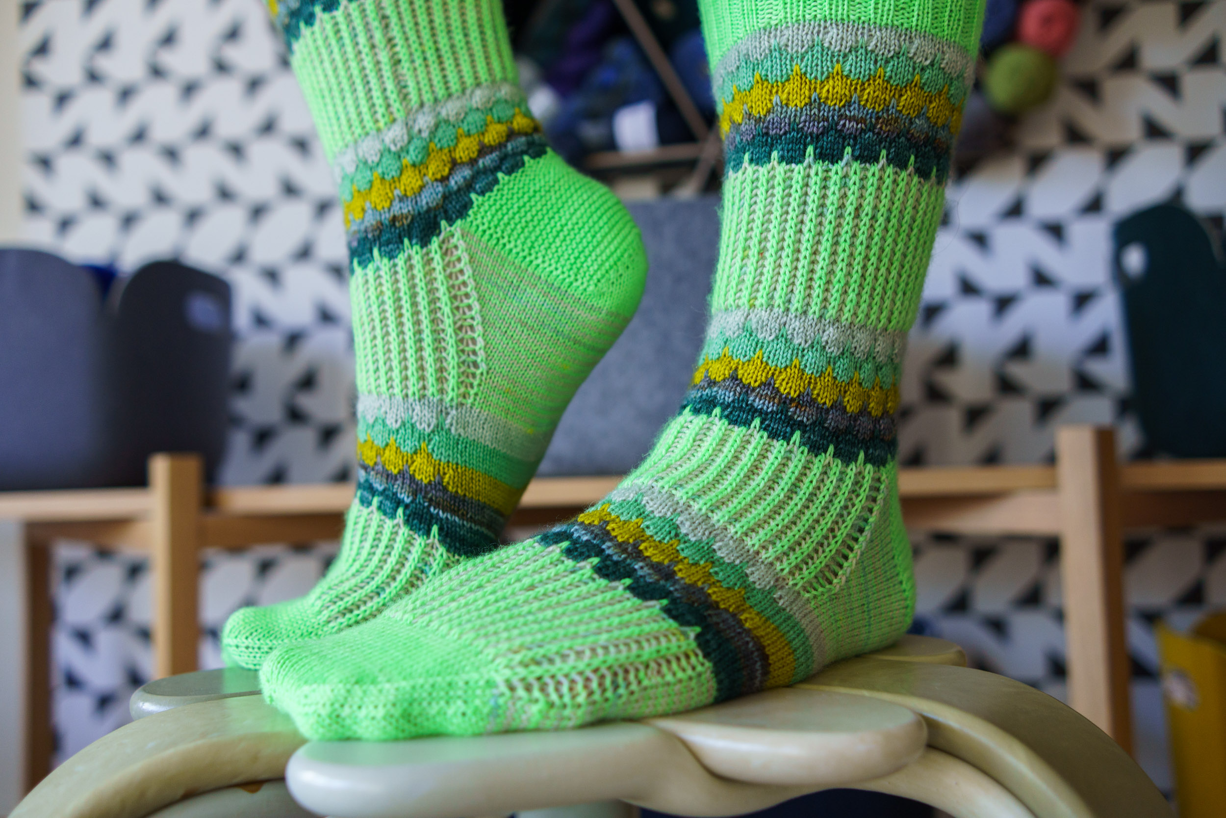 Image shows Stephen standing on a stool wearing the Bubbles & Brioche socks