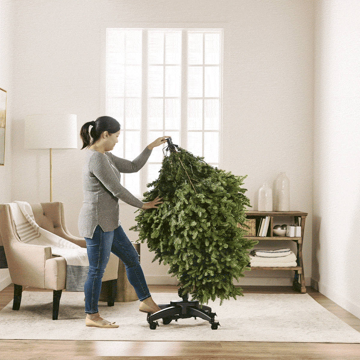 Animated GIF of a woman effortlessly flipping a Balsam Hill Tree